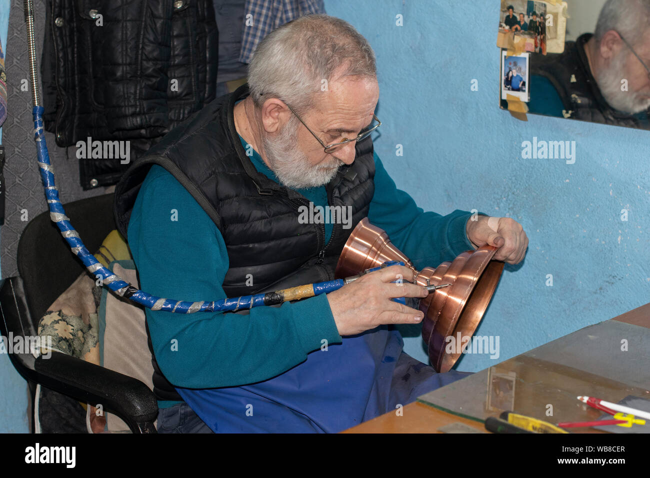 Coppersmith is working in his shop in Suleymaniye, Istanbul. Copper ...