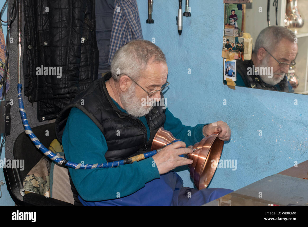 Coppersmith is working in his shop in Suleymaniye, Istanbul. Copper ...