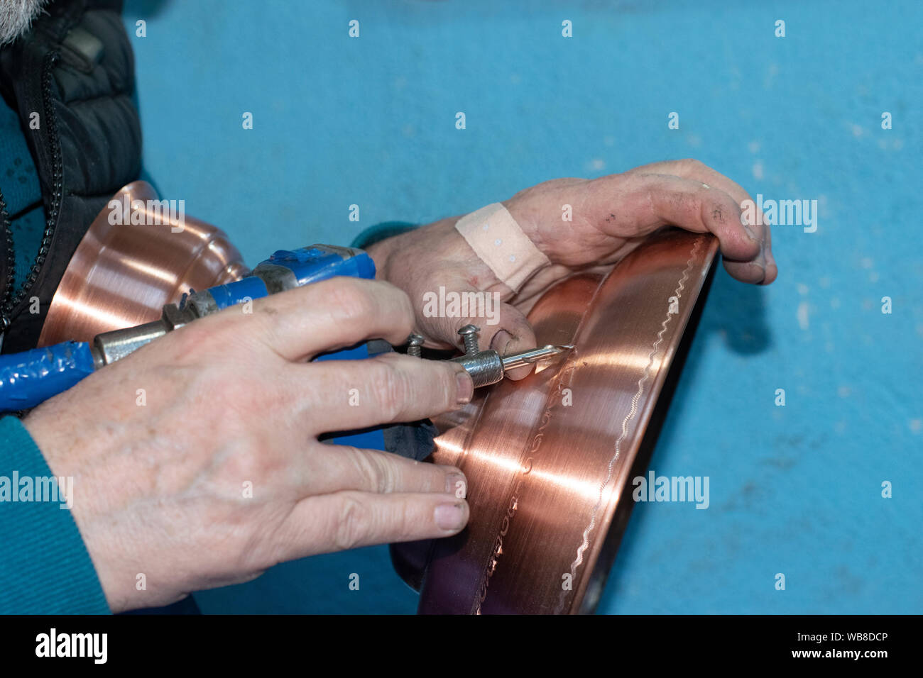 Coppersmith working at work. Working with engraving pen during hand ...