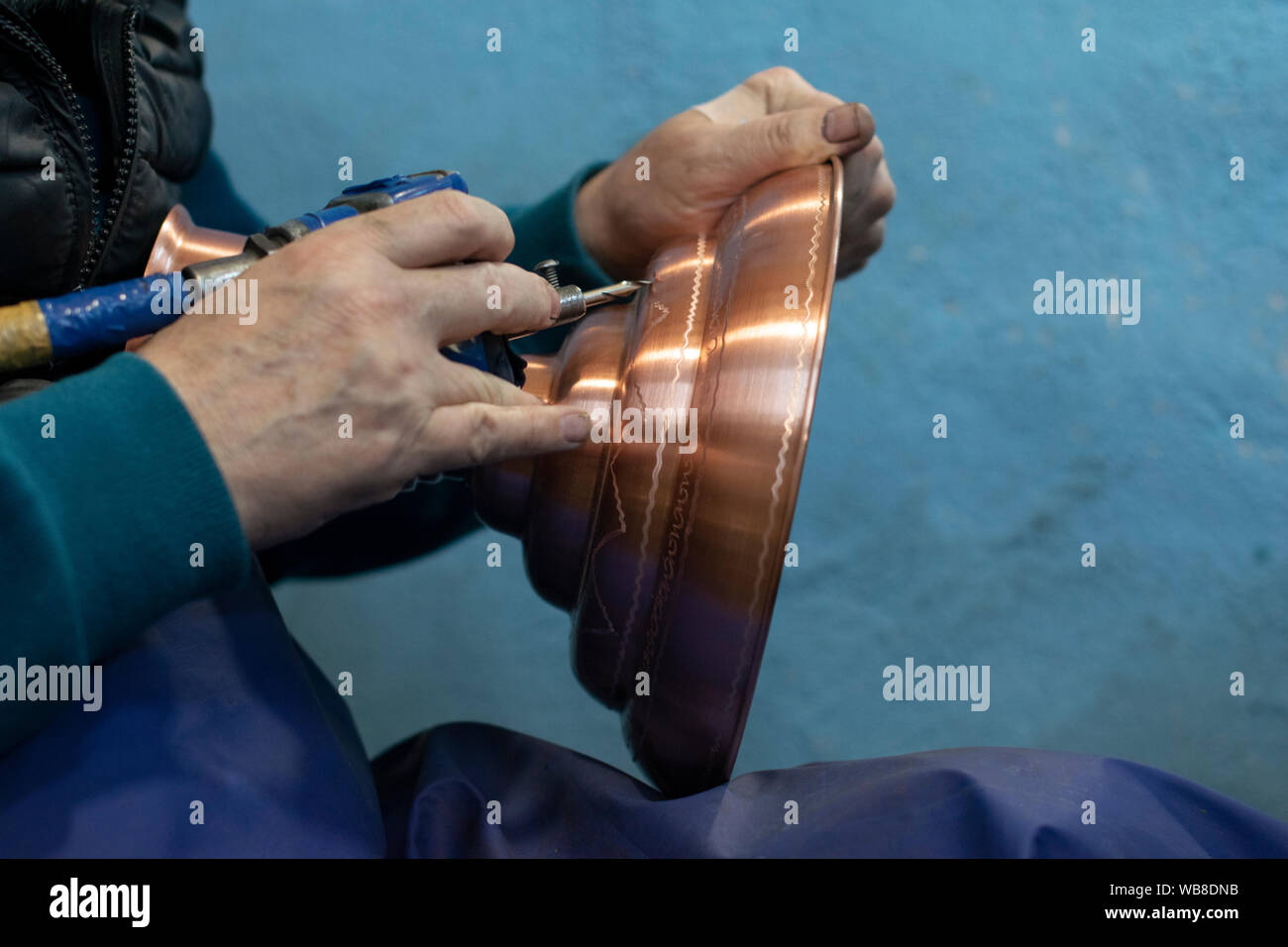 Coppersmith working at work. Working with engraving pen during hand ...