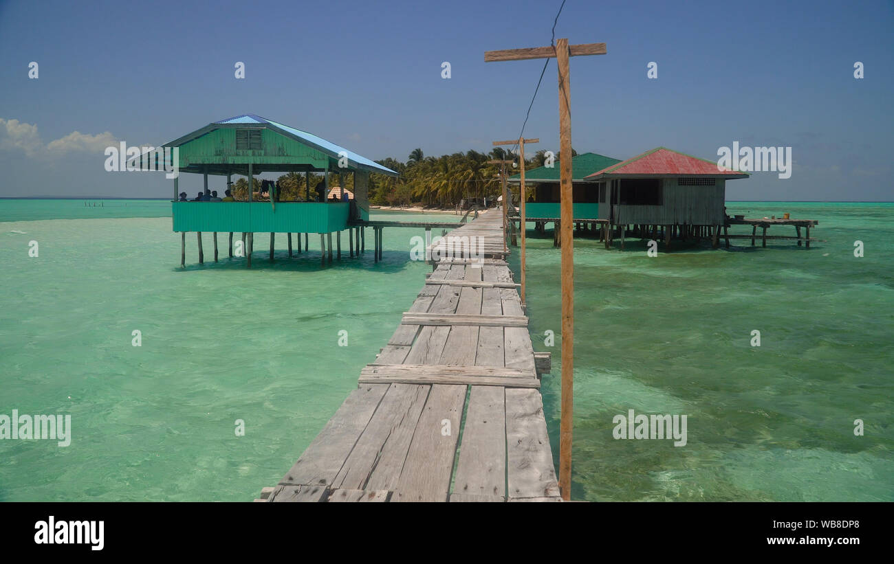 A pier with wooden arbors on a tropical island. Onok Island, Balabac ...