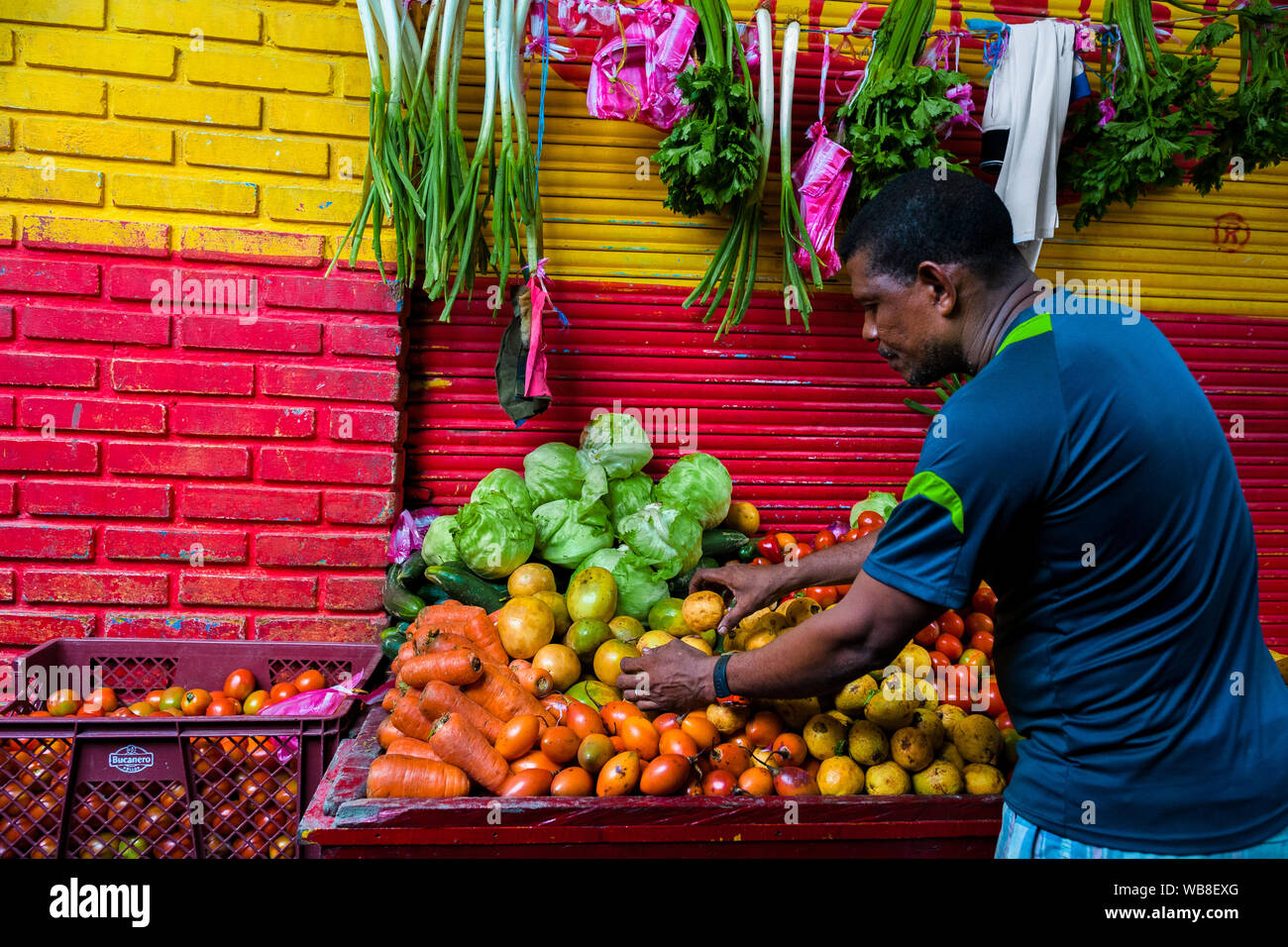 An Afro-Colombian market vendor sells fresh fruits and vegetables in ...