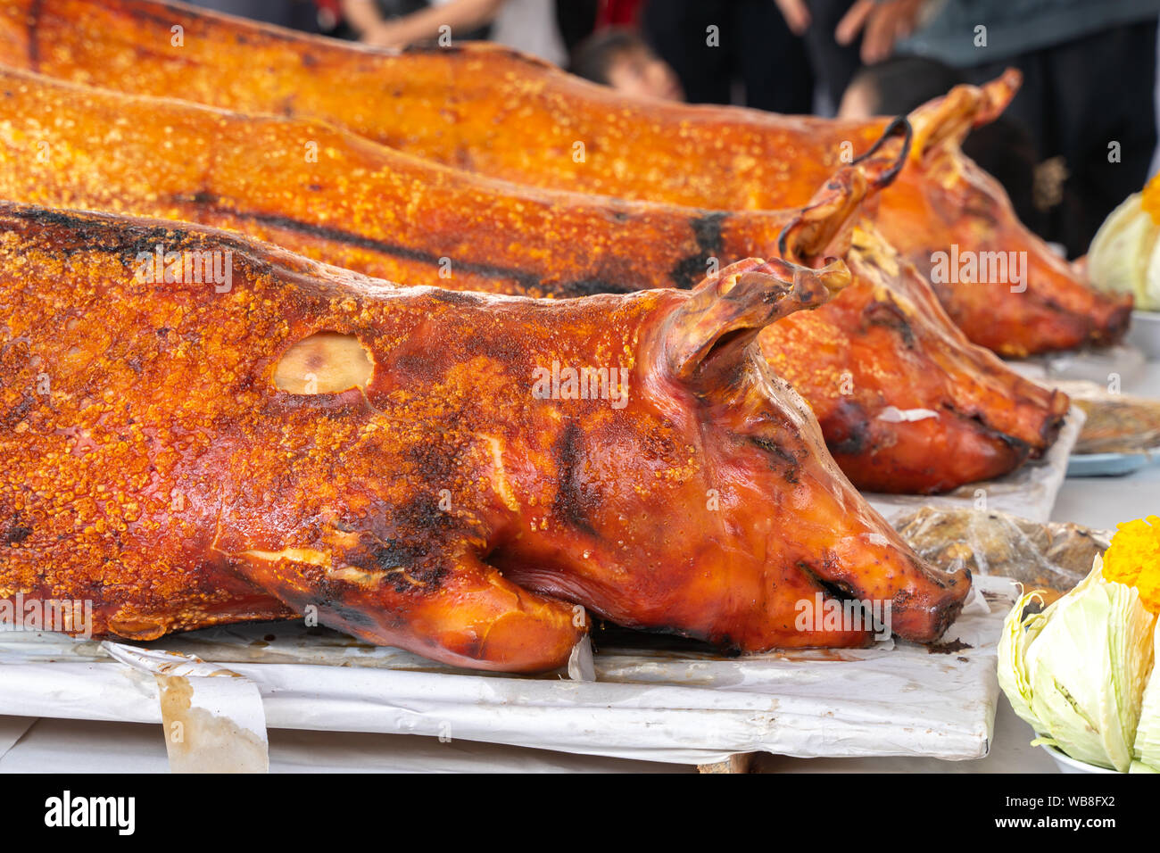 Pigs roast cooked over hot coals, grilled pig on the fire Stock Photo ...