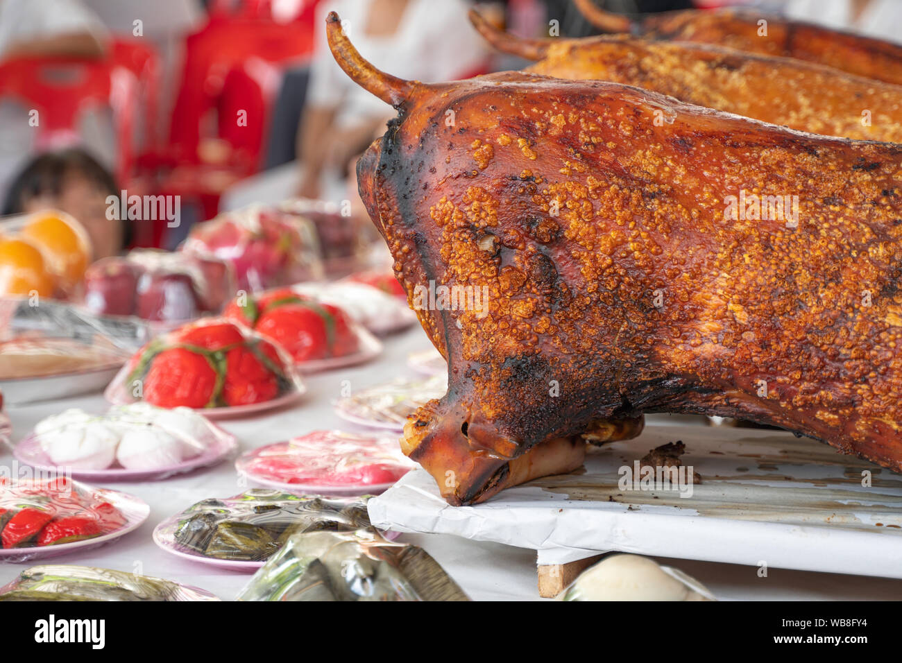 Pigs roast cooked over hot coals, grilled pig on the fire Stock Photo ...