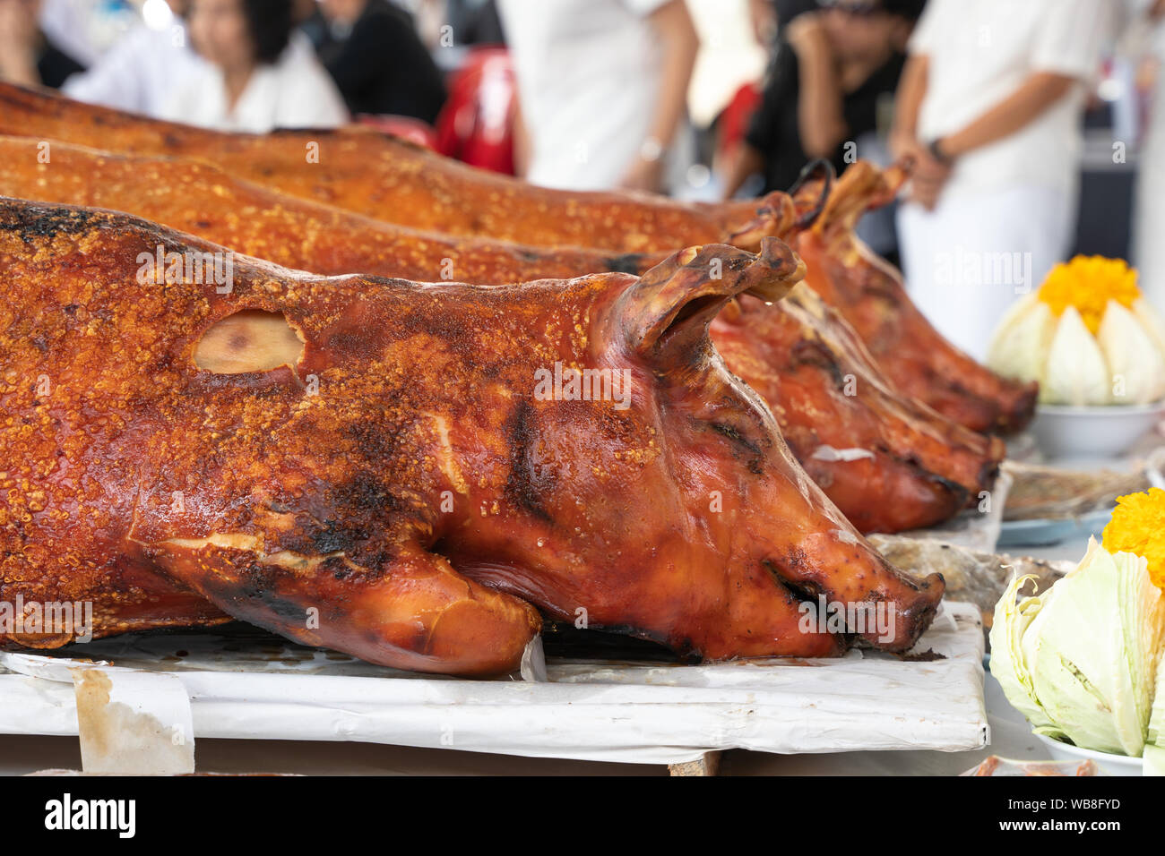 Pigs roast cooked over hot coals, grilled pig on the fire Stock Photo ...