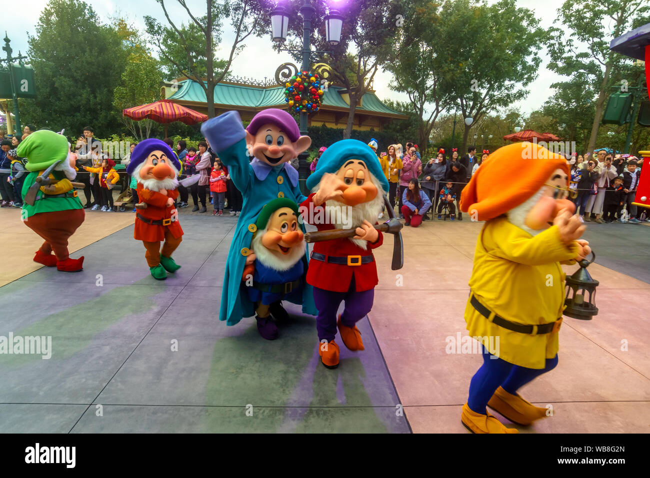Tourists watch the parade at Shanghai Disneyland at the Shanghai Disney ...