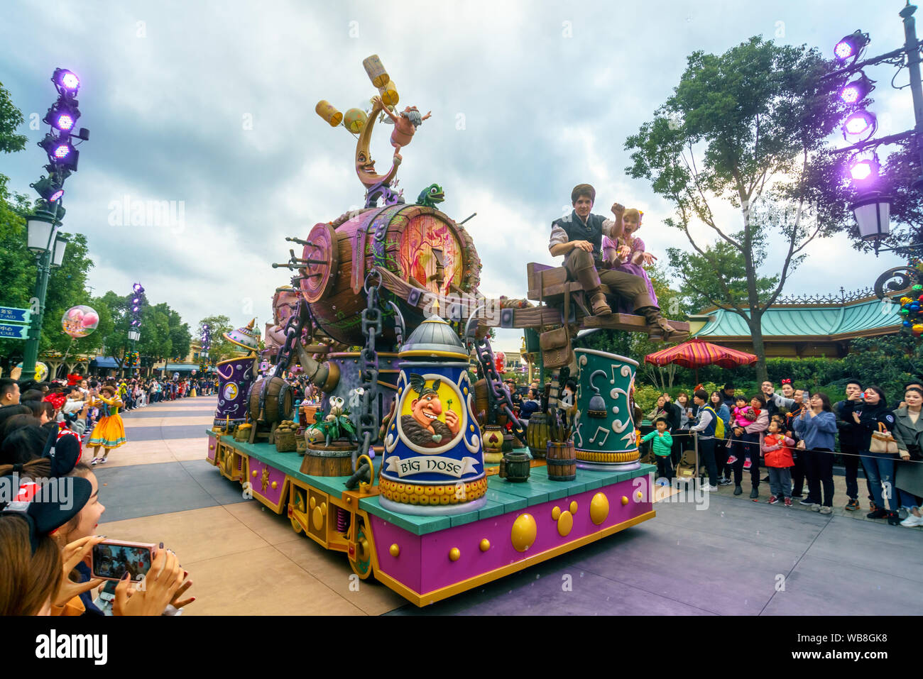 Tourists watch the parade at Shanghai Disneyland at the Shanghai Disney ...
