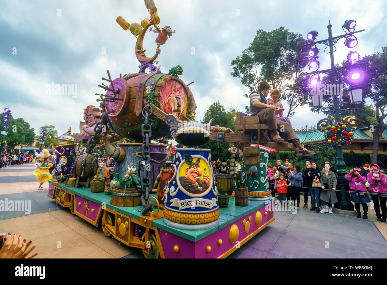 Tourists watch the parade at Shanghai Disneyland at the Shanghai Disney ...