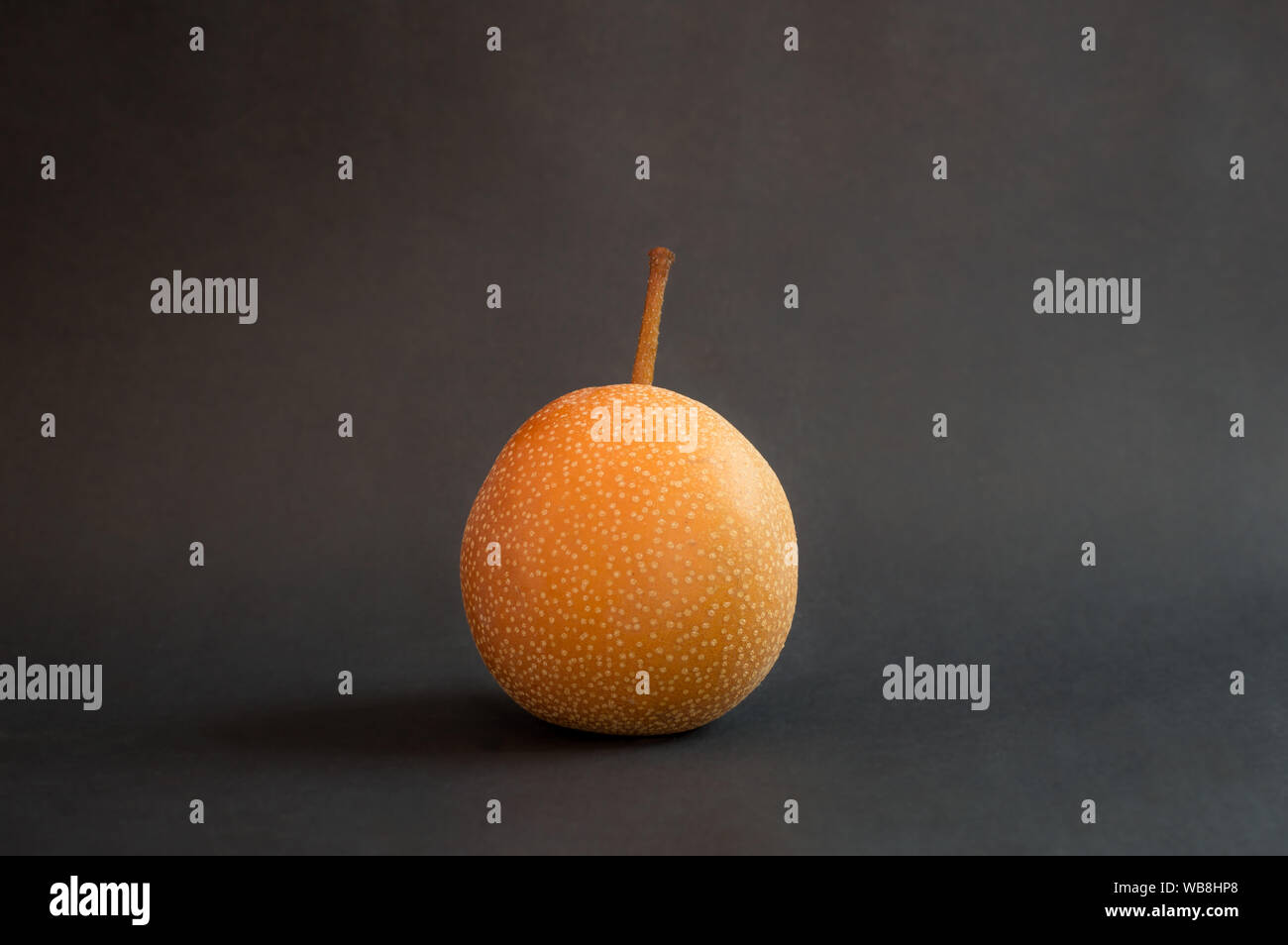 Fresh Nashi or Asian pears isolated on dark background. Close up of ...