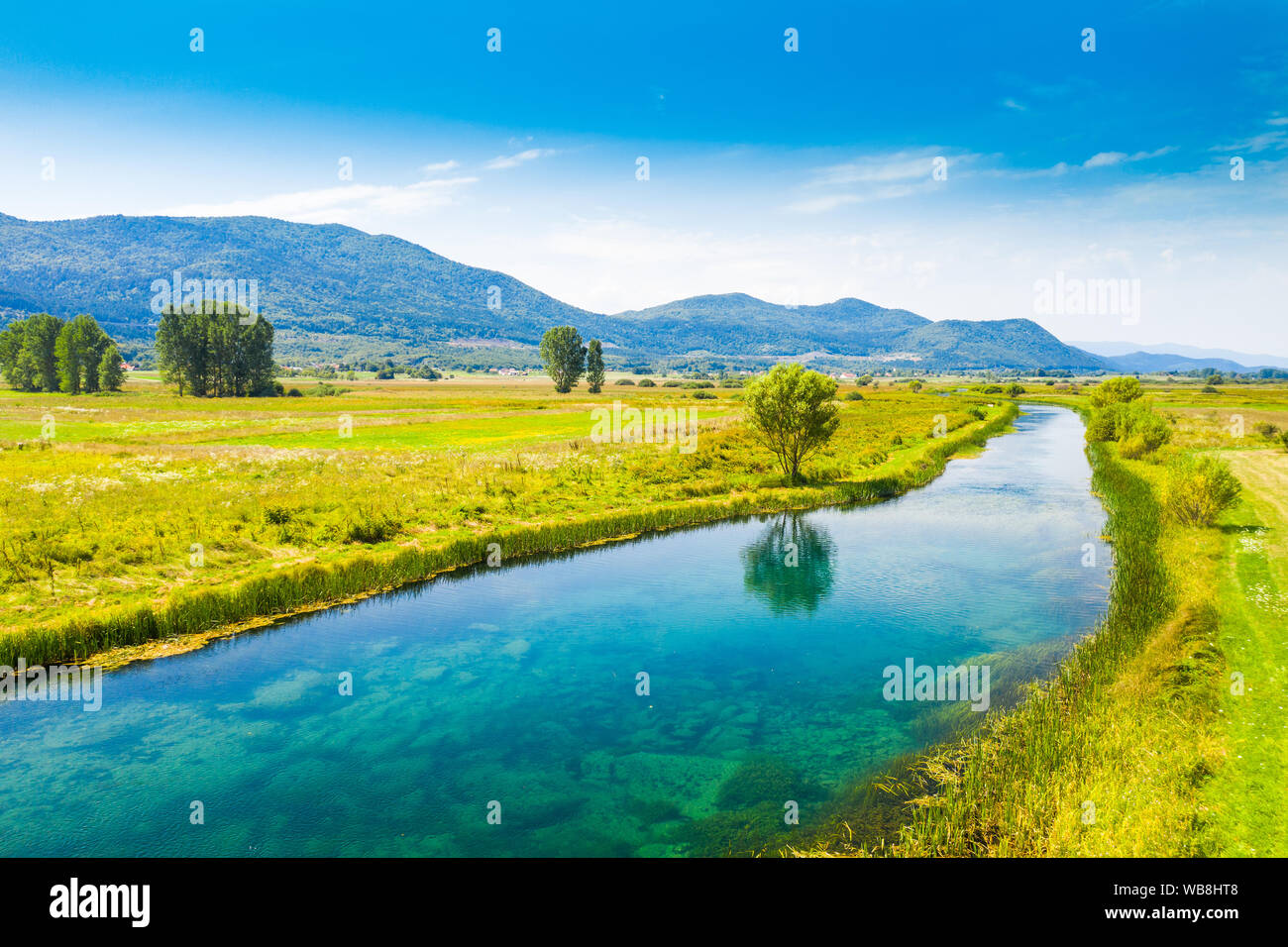 Beautiful nature landscape, Gacka river among grass banks, Lika region ...