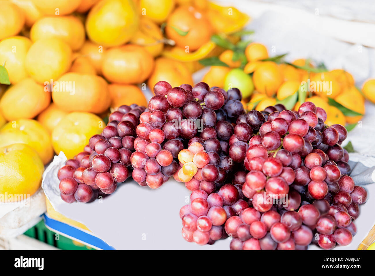 Asian fruit assortment such as grapes and orange on display in Hoi An ...