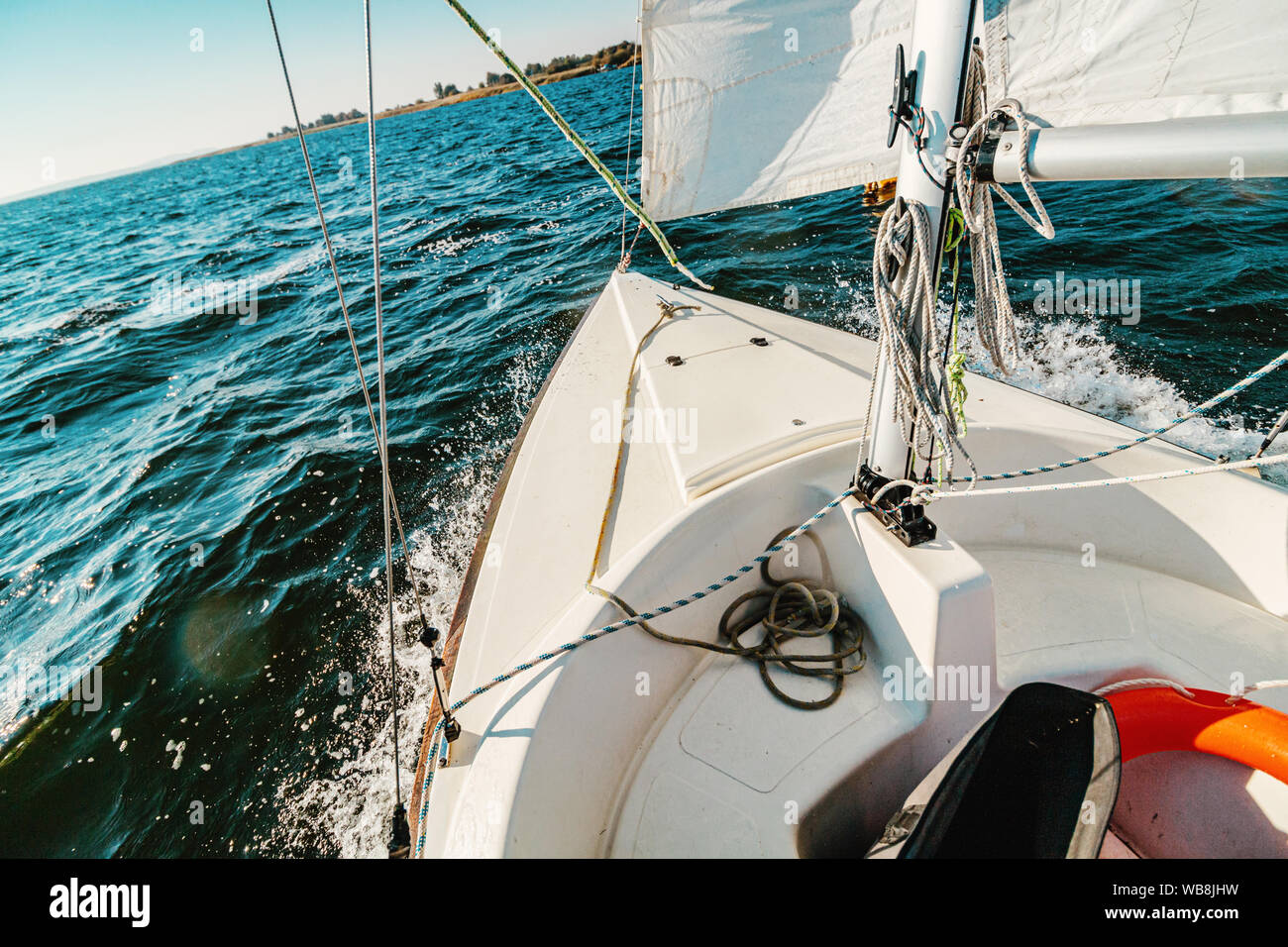 Waves and spray while sailing on a small yawl Stock Photo - Alamy