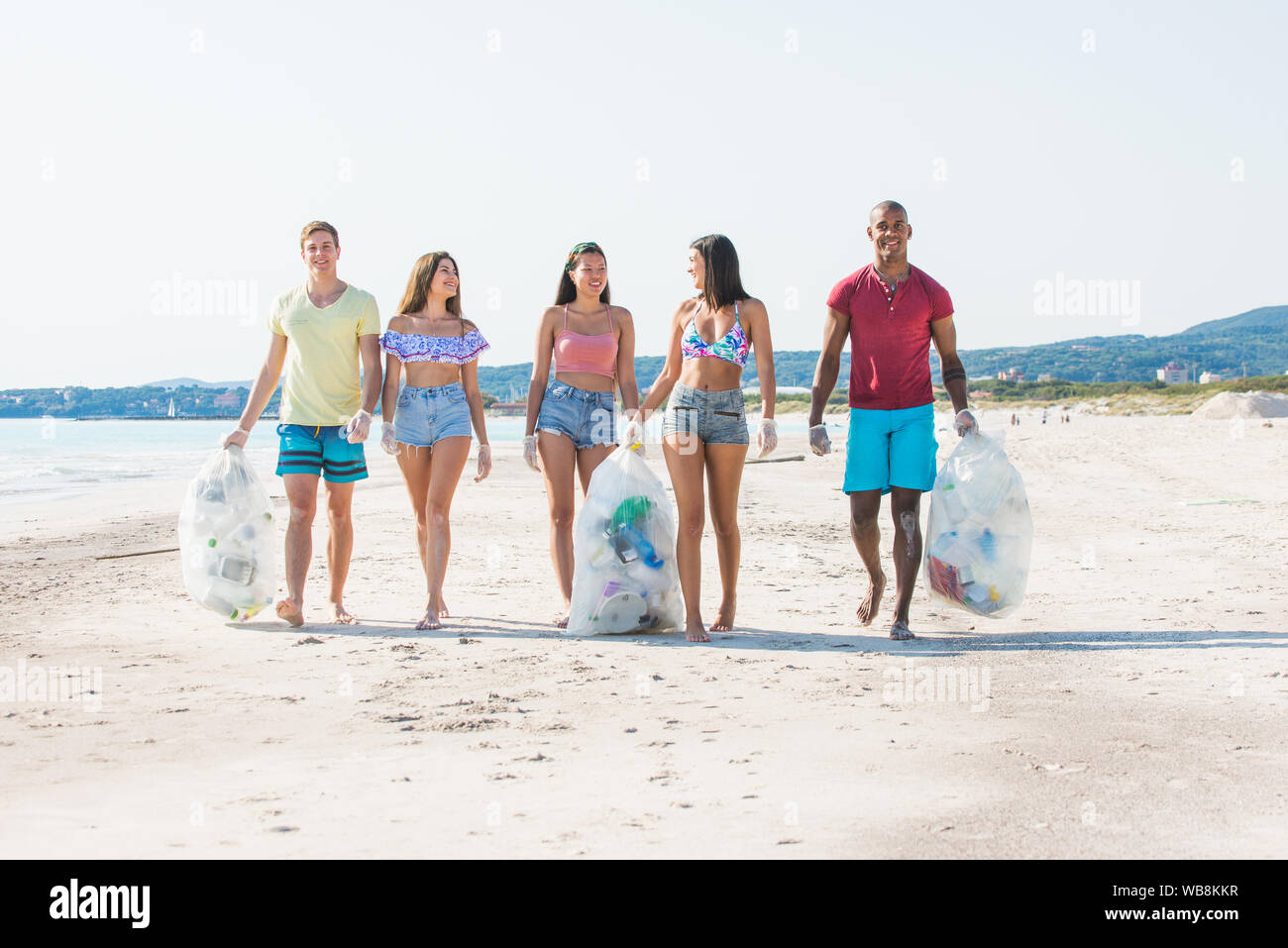 Group of activists friends collecting plastic waste on the beach ...