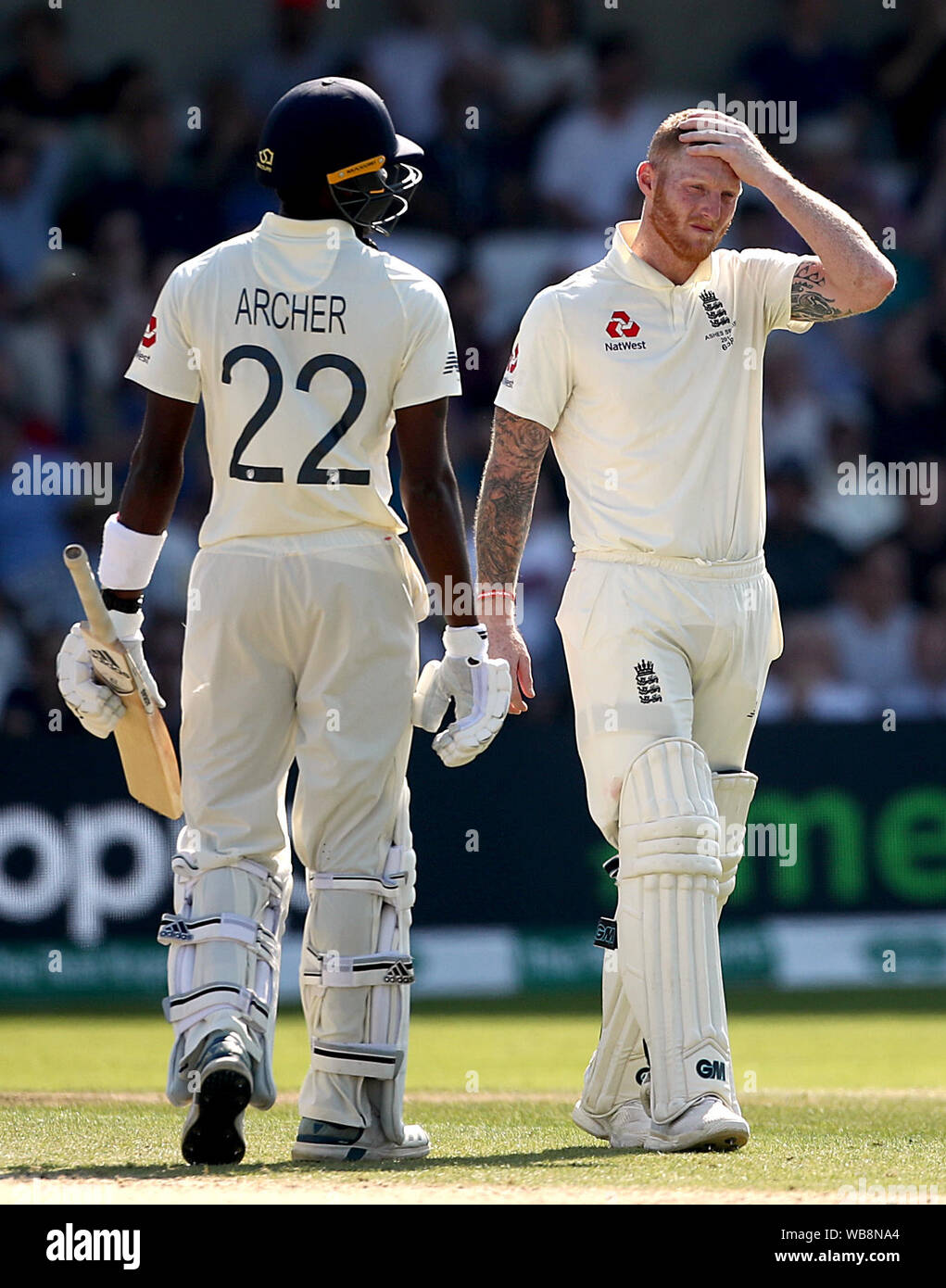 England's Ben Stokes (right) reacts after Jofra Archer (left) is caught ...