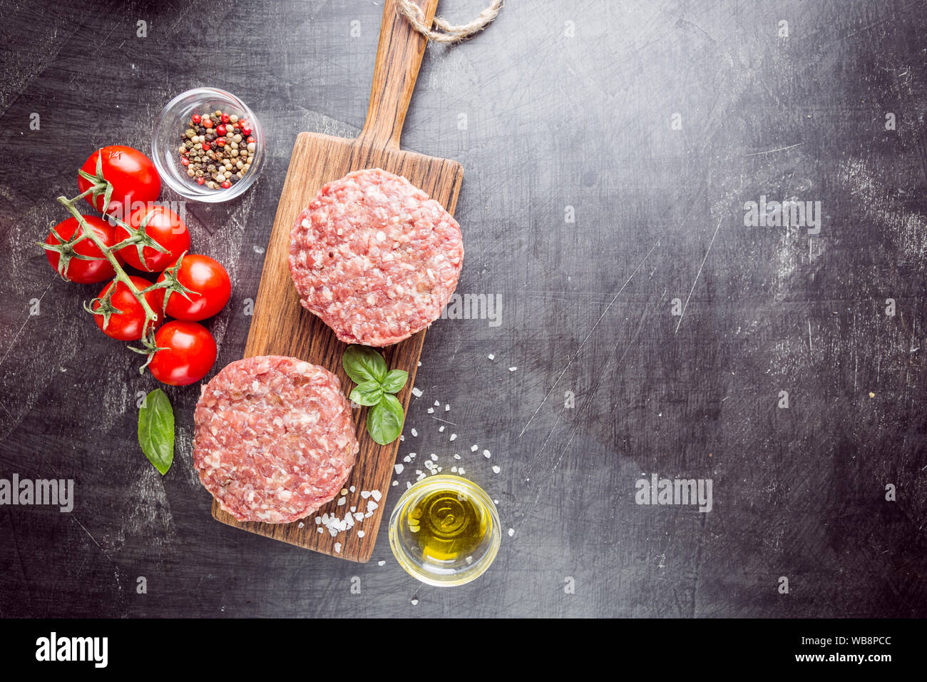 Fresh raw Prime Black Angus beef burger patties on black background ...