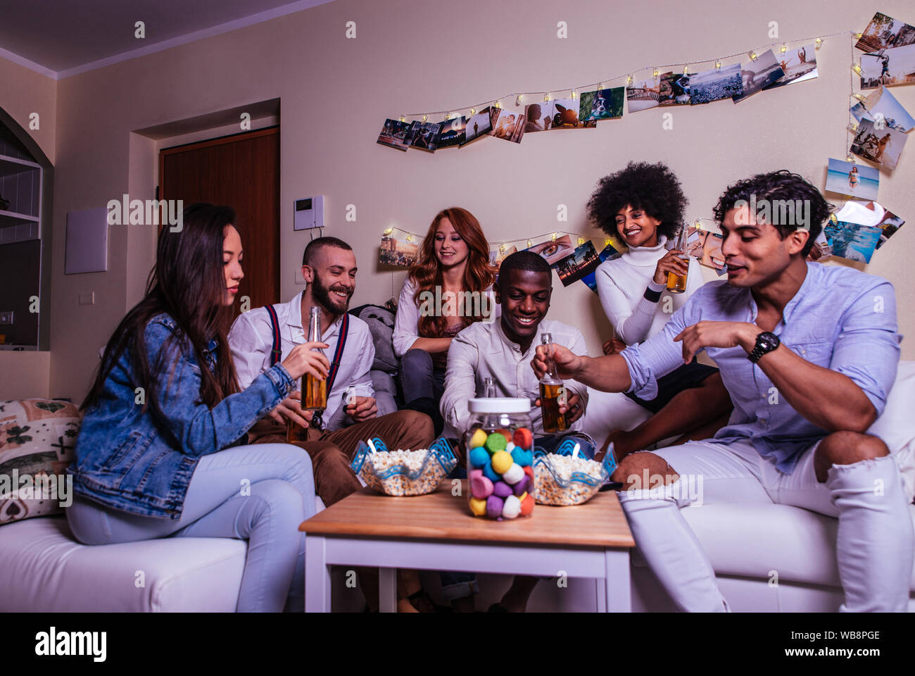 A group of young people celebrating and making party at home Stock ...