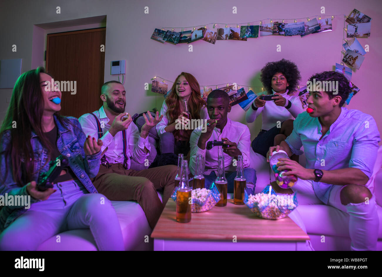 A group of young people celebrating and making party at home Stock ...