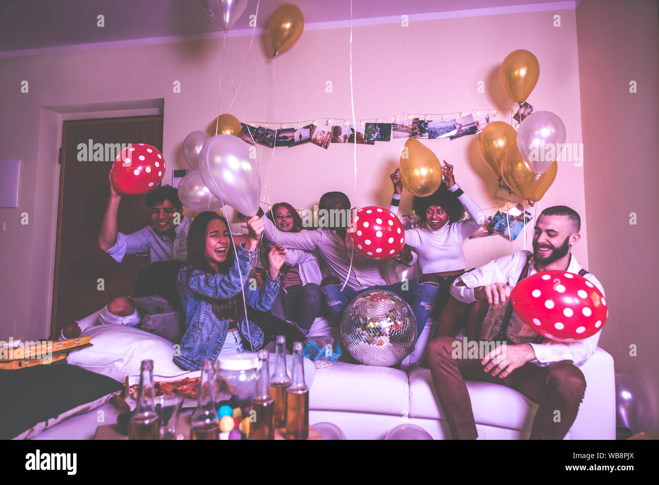A group of young people celebrating and making party at home Stock ...
