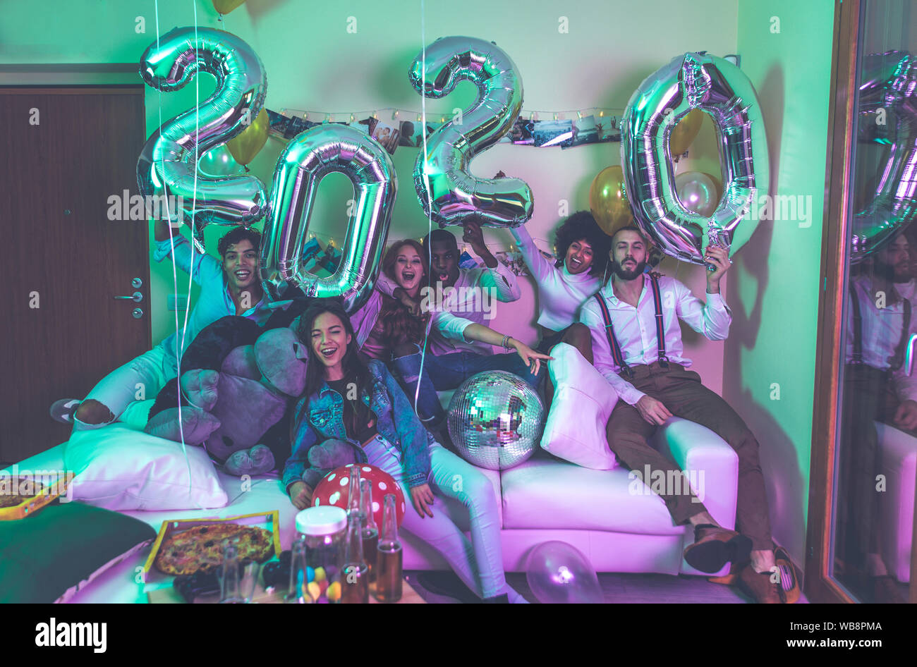 A group of young people celebrating and making party at home Stock ...