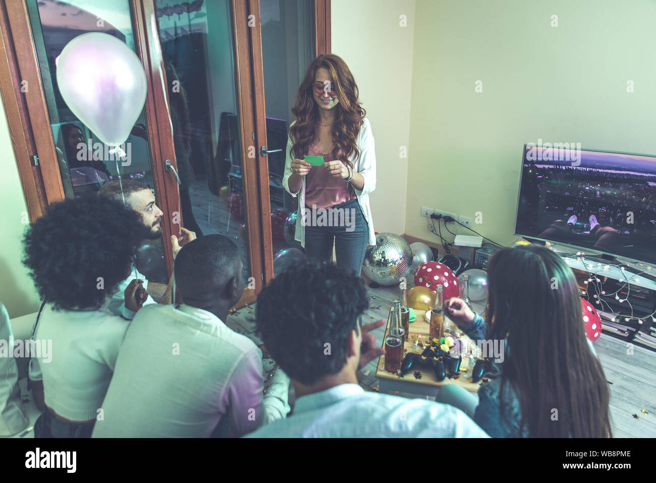 A group of young people celebrating and making party at home Stock ...