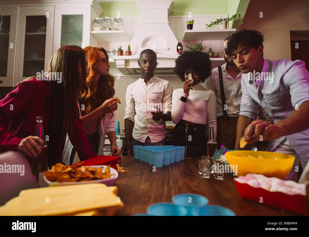 A group of young people celebrating and making party at home Stock ...
