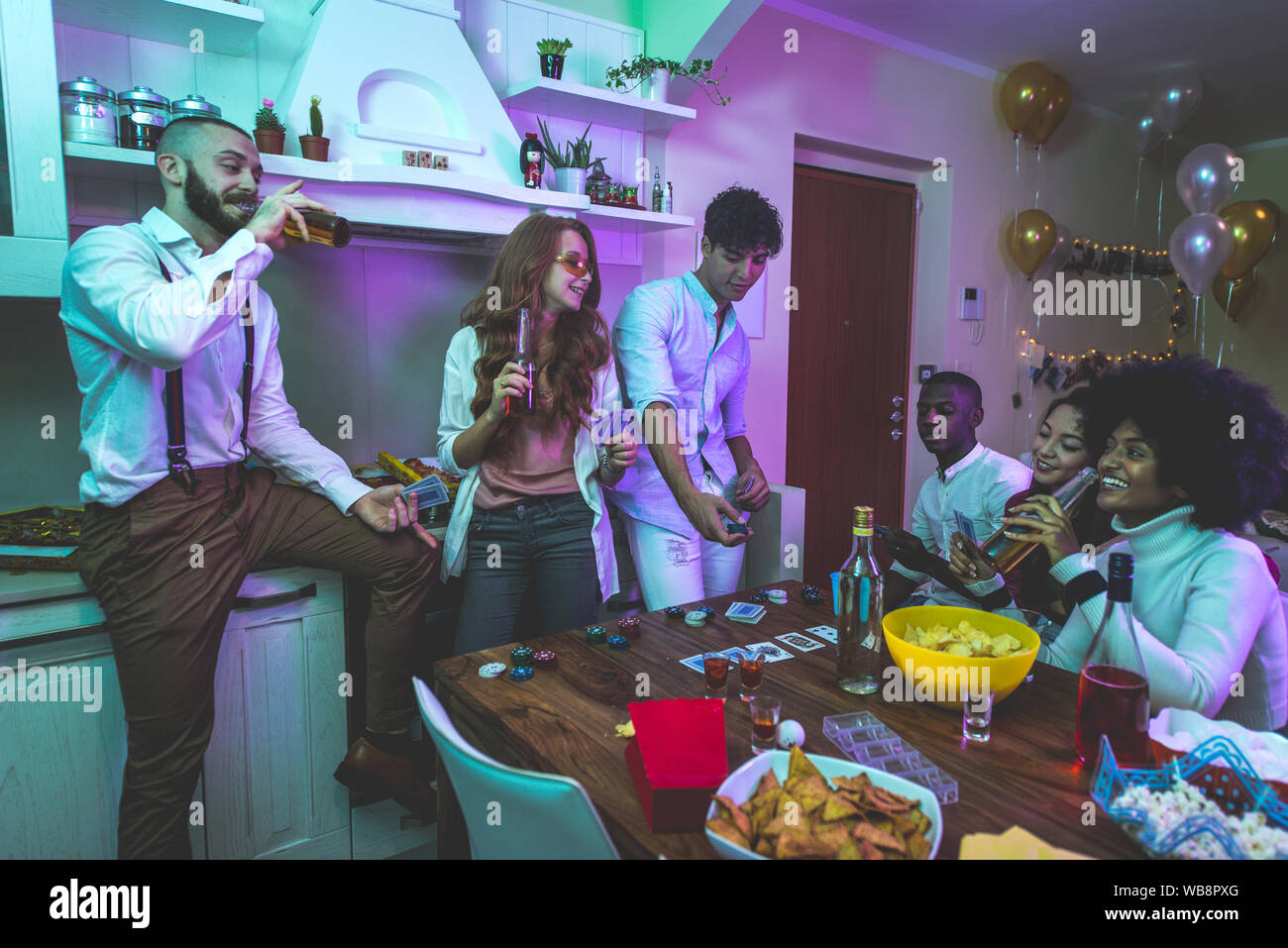 A group of young people celebrating and making party at home Stock ...