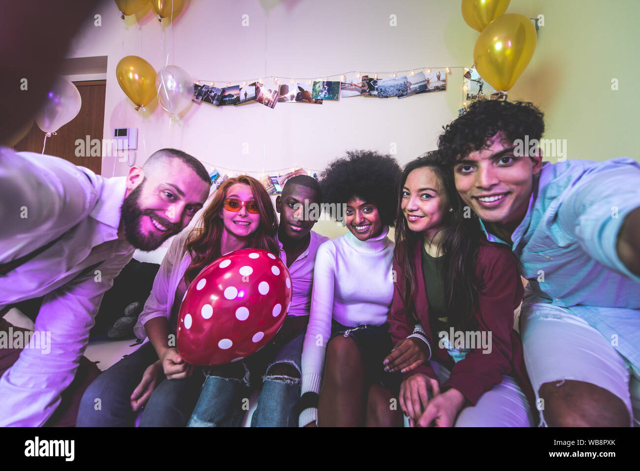 A group of young people celebrating and making party at home Stock ...