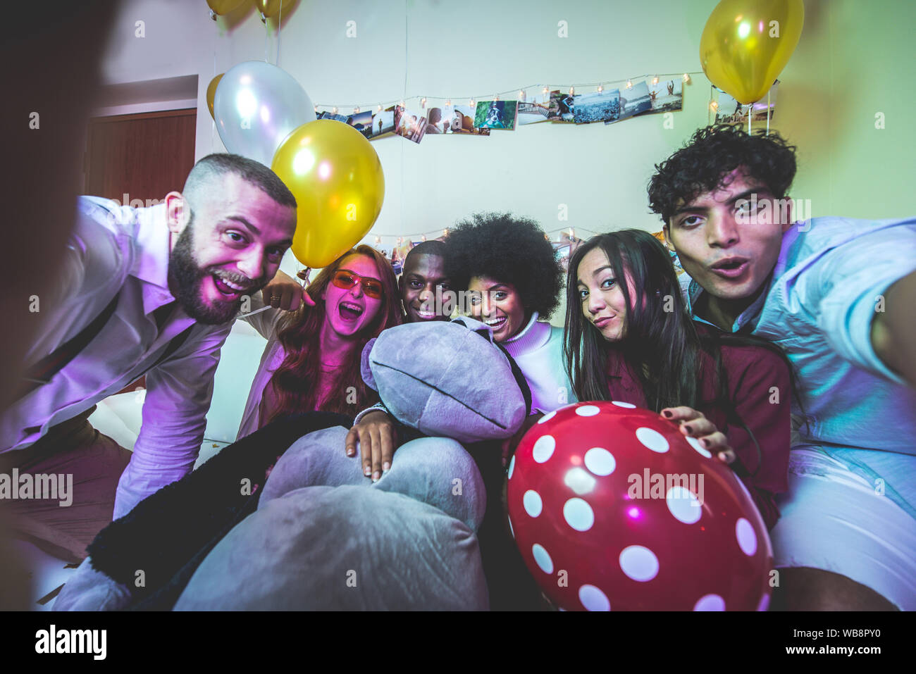 A group of young people celebrating and making party at home Stock ...