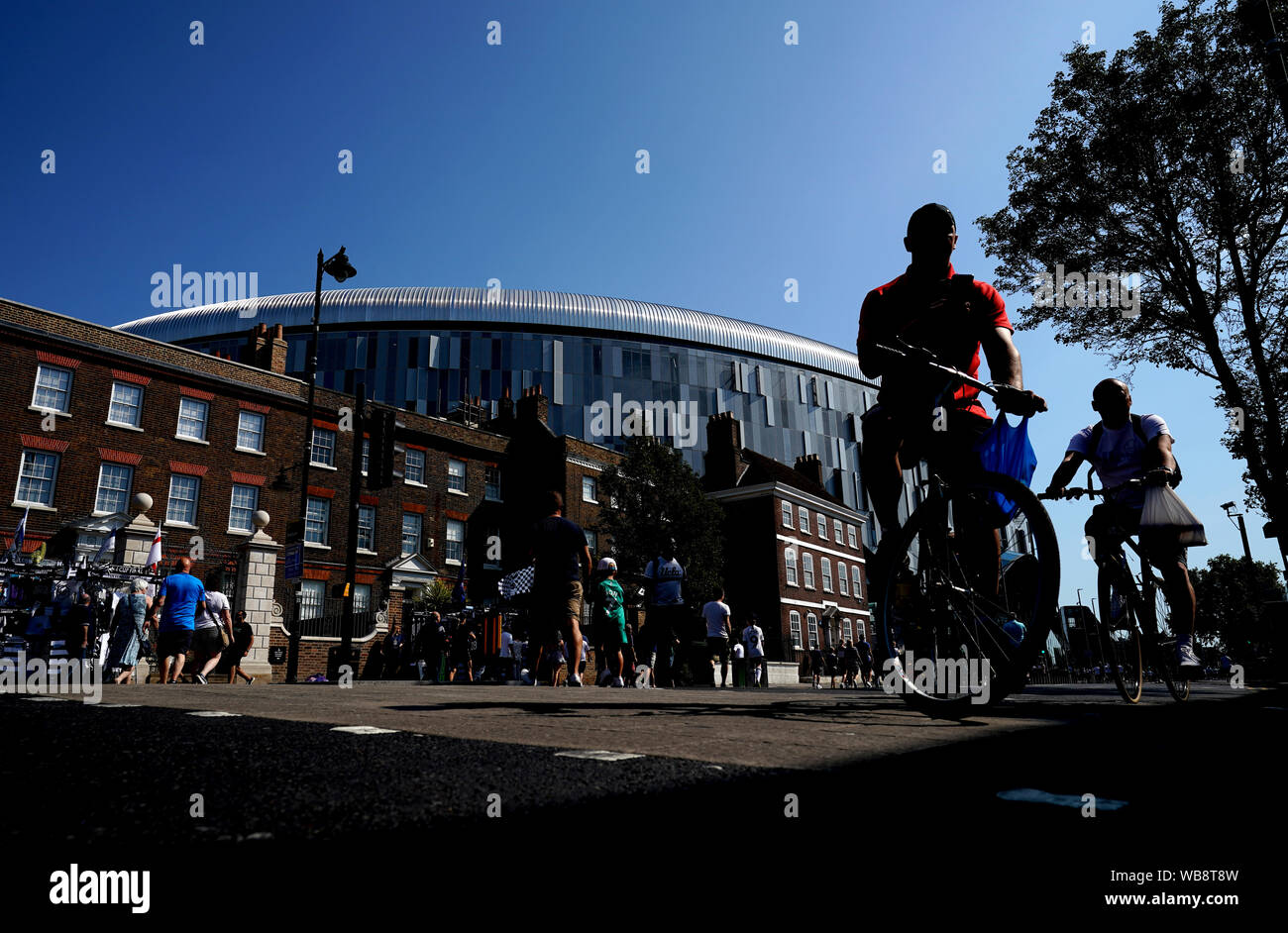 Fans arrive at the stadium ahead of the Premier League match at ...