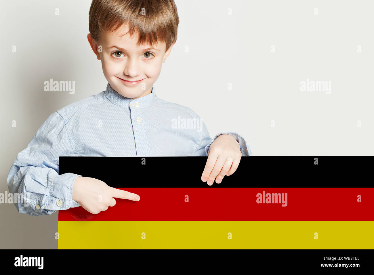 Happy child boy holding the Deutsch flag on white background Stock ...