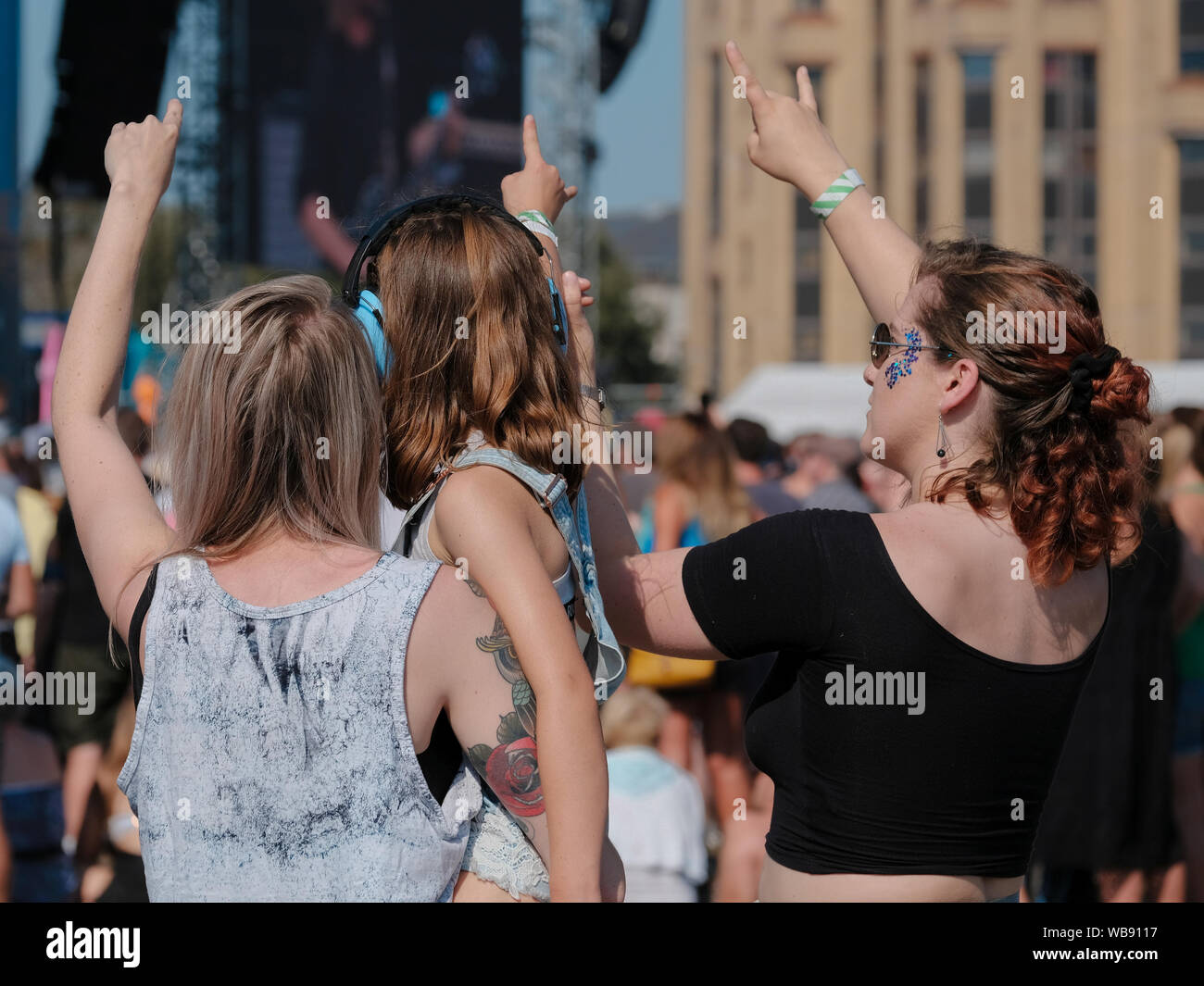 Child wearing ear defenders at music festival hi-res stock photography ...