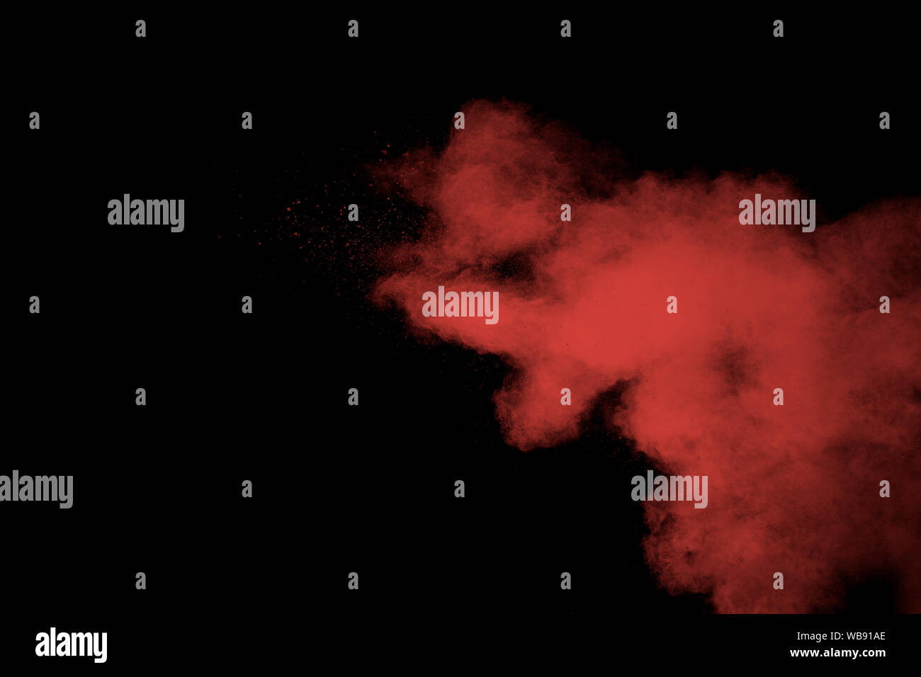 Red color powder explosion on black background.Freeze motion of red ...