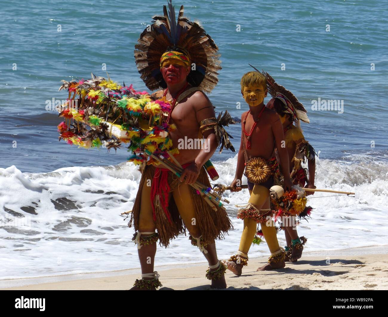 Indigenous Tupiniquim tribe people walking along the Taperapuã beach ...