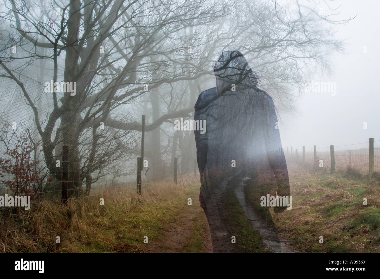 A double exposure of a spooky silhouette of a woman. On a country path ...