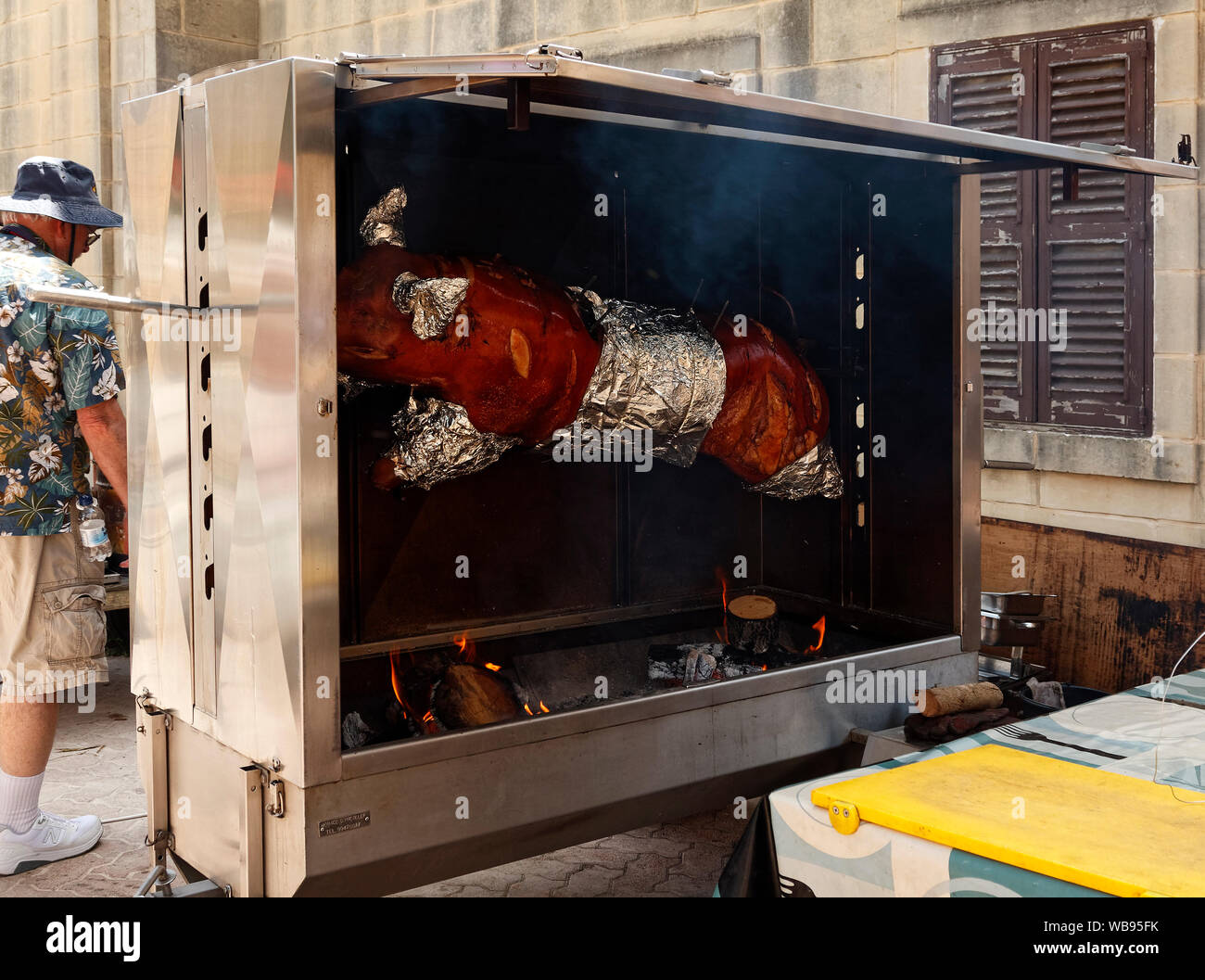 whole pig roasting, wood fire, outdoor spit, food, celebration, meat ...