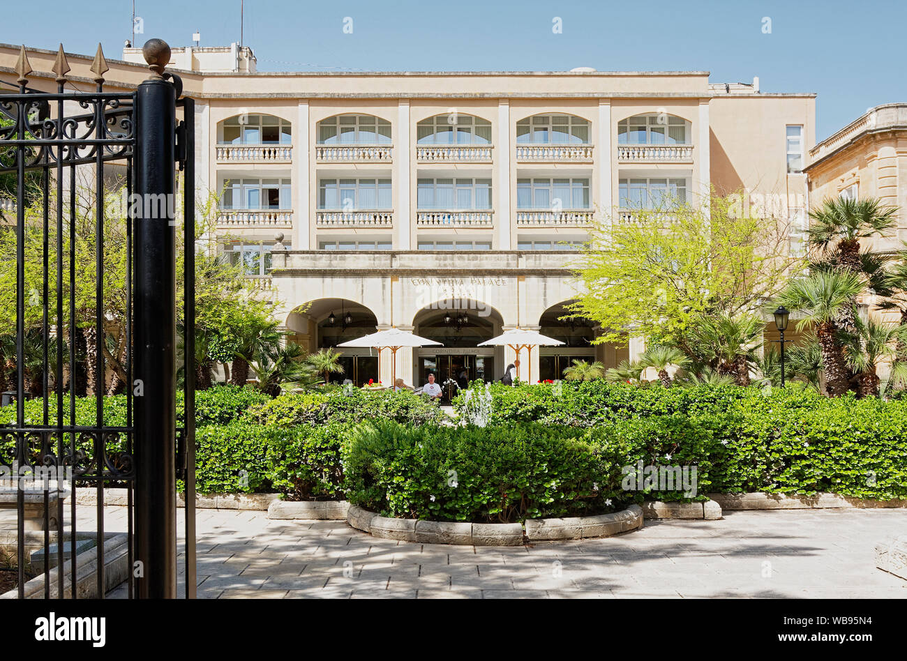 Corinthia Palace Hotel; main entrance, garden, trees, shrubs, umbrellas ...