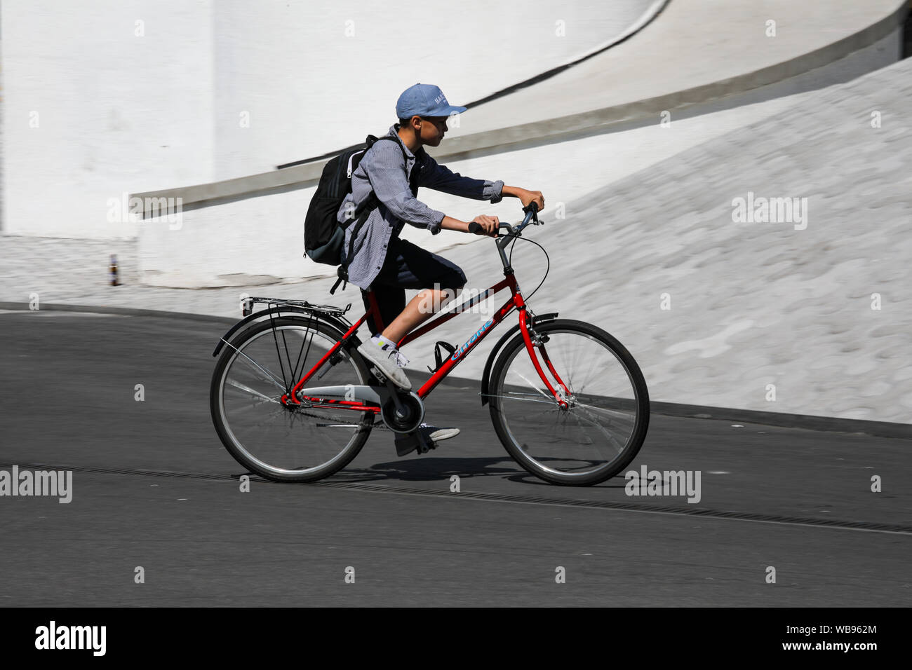 Boy with a red bicycle Stock Photo - Alamy