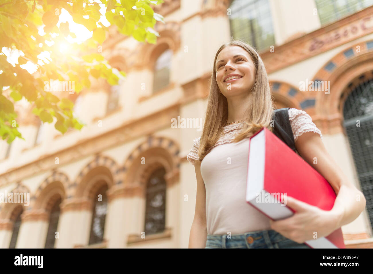 Portrait of a smiling student in front of her university Stock Photo ...