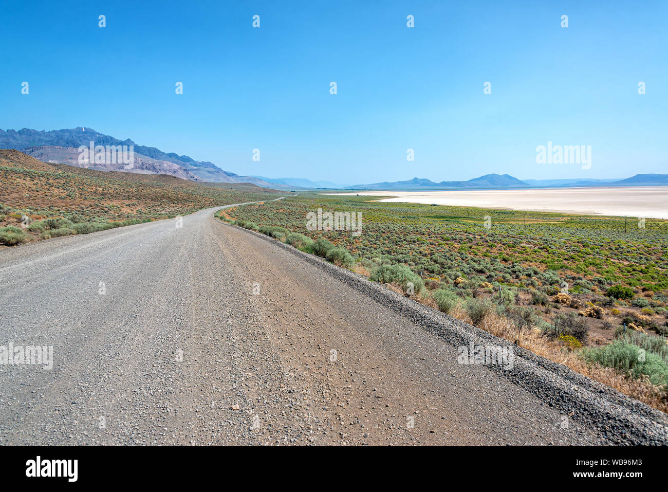 Gravel road passing through the Alvord Desert in southeast Oregon in ... Gravel road passing through the Alvord Desert in southeast Oregon in ...