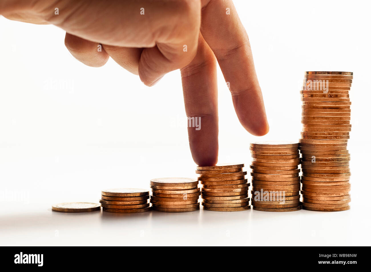 Fingers are climbing a Coin graph on a white background Stock Photo - Alamy