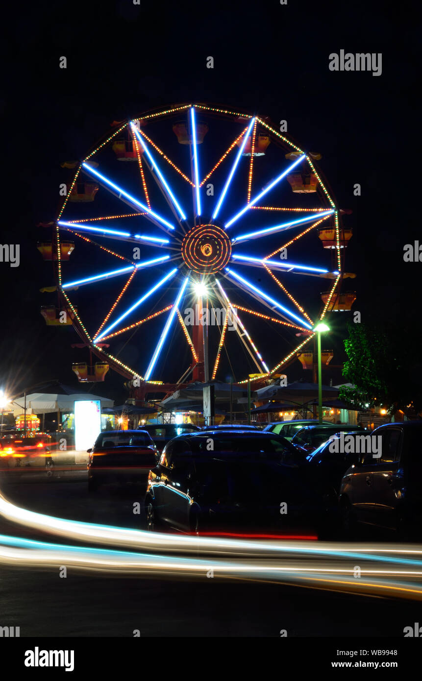 Night view of a Ferris wheel and car trails Stock Photo - Alamy
