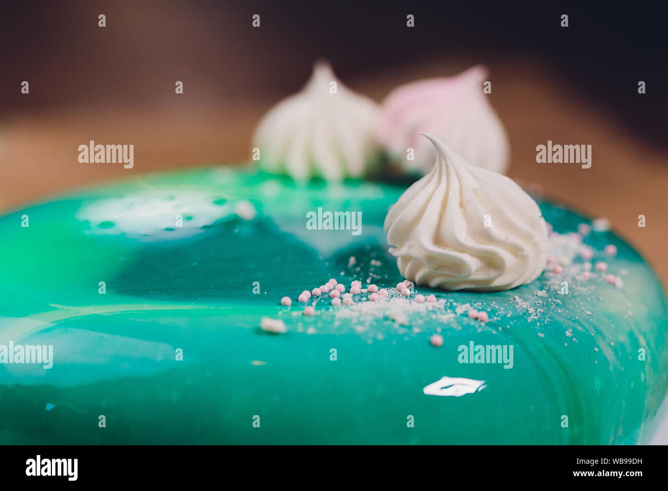 Modern French mousse cake with green mirror glaze. Picture for a menu ...