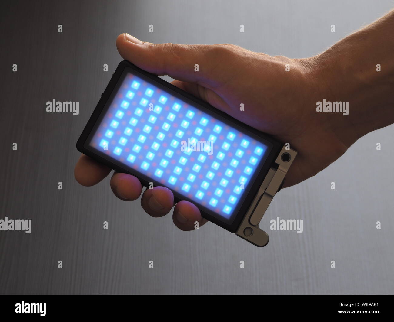 RGB light on a man hand, dark background. Blue light Stock Photo - Alamy