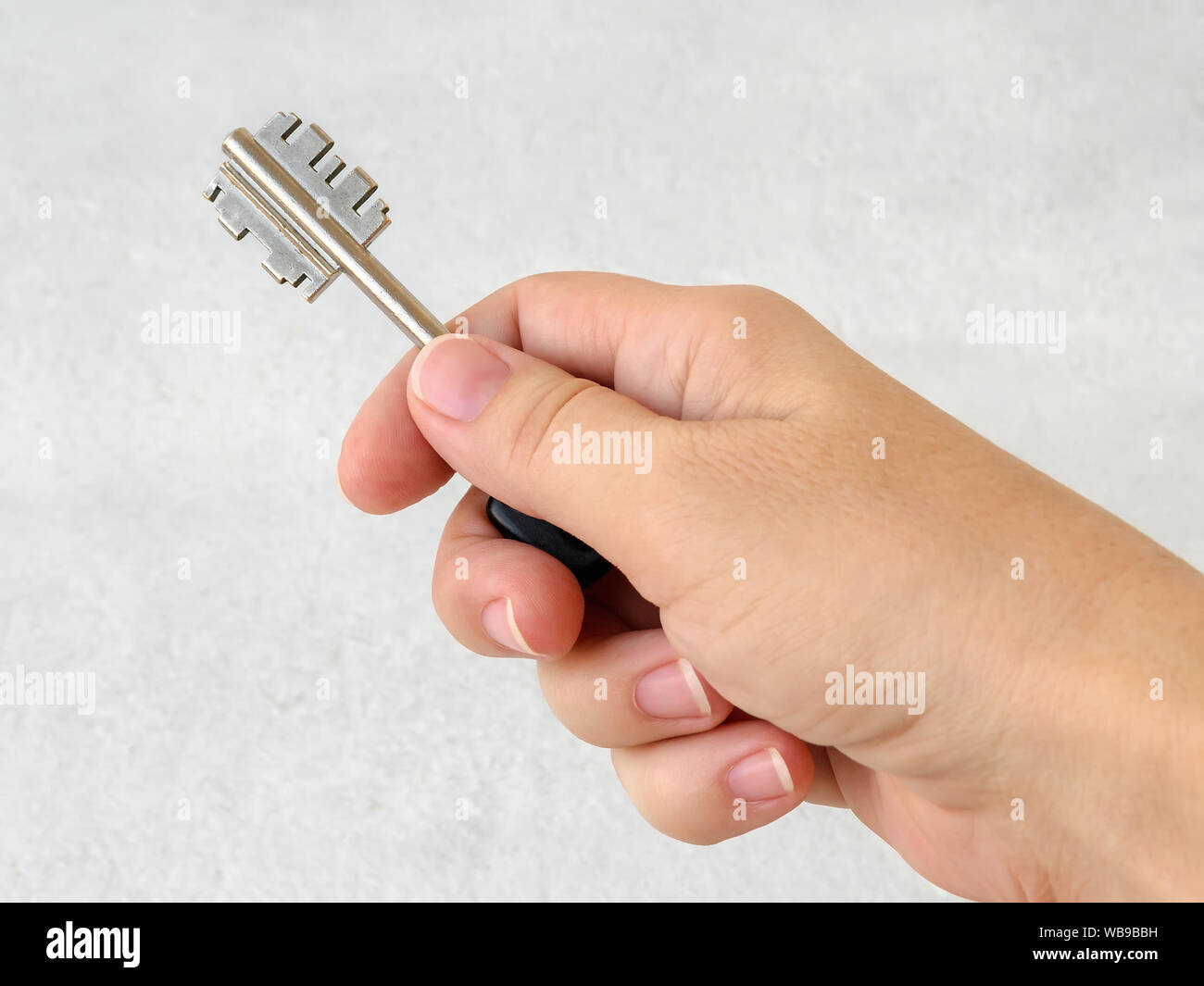 Woman hand with key. Caucasian woman hand holding one large house key ...