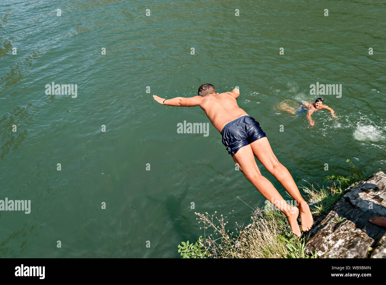 Boys jumping into lake hi-res stock photography and images - Alamy