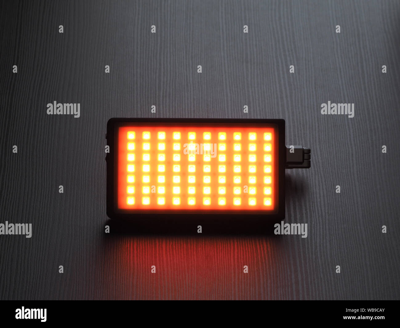 RGB light on a dark background. Orange light Stock Photo - Alamy