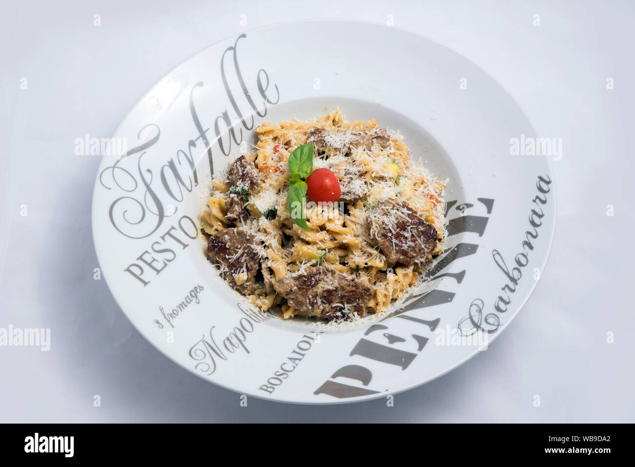 A high contrast Hero shot of a Meat & sprinkled Cheese Pasta, on a ...