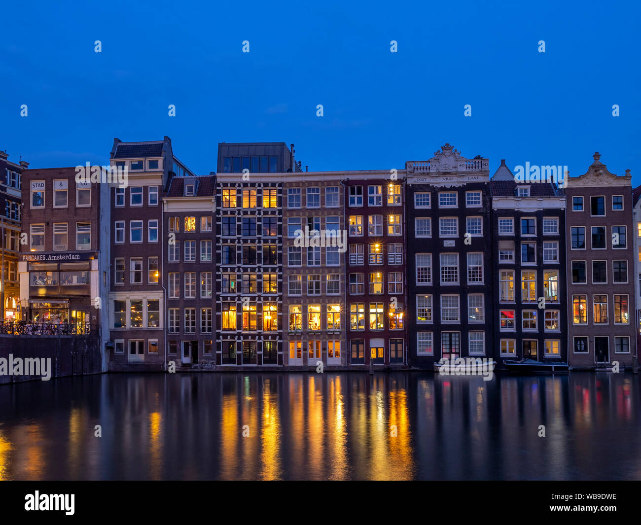 Historic buildings on the Damrak canal in the centre of beautiful ...