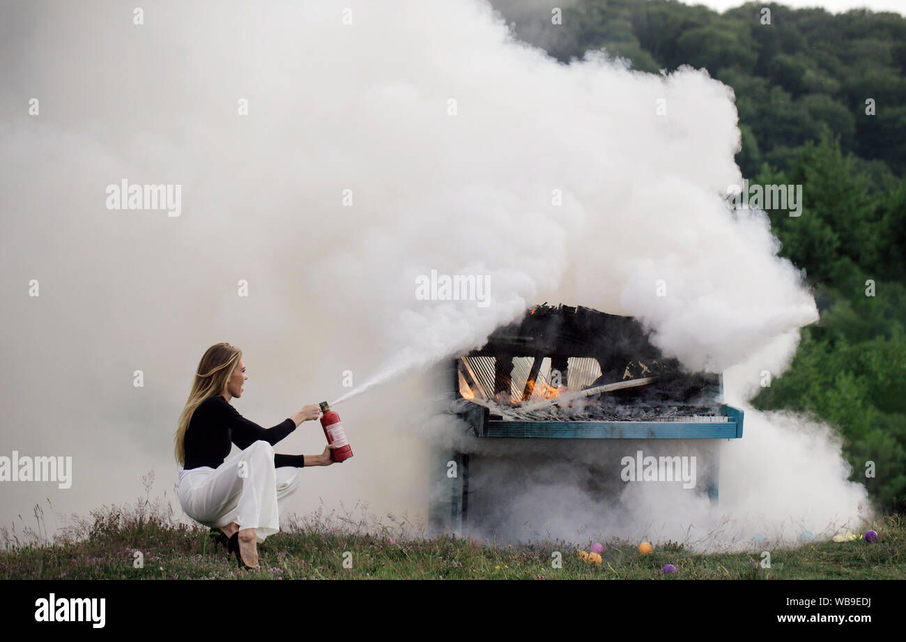 Firefighting of girl with extinguisher. firefighting with woman holding ...