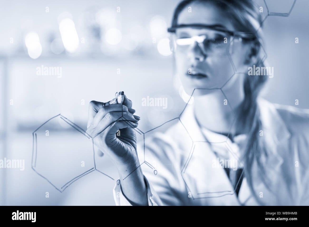 Portrait of a confident female researcher in life science laboratory ...